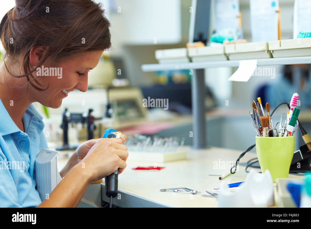 Dental technician milling a tooth for dentures Stock Photo - Alamy