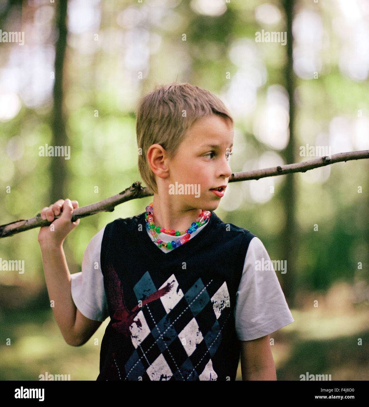 Boy playing in a forest, Sweden Stock Photo - Alamy