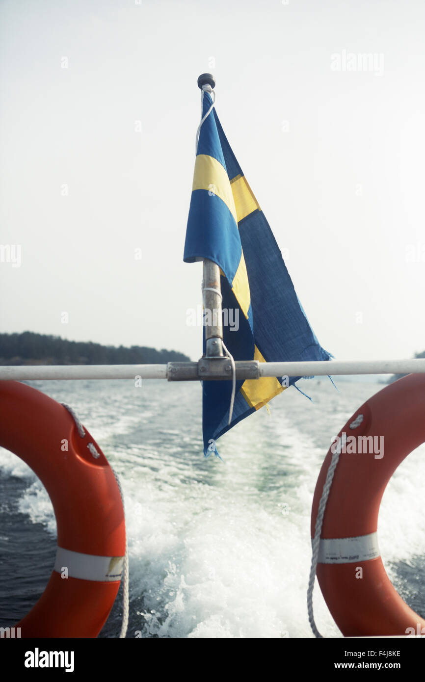 A flag on the stem of a boat, Sweden Stock Photo - Alamy