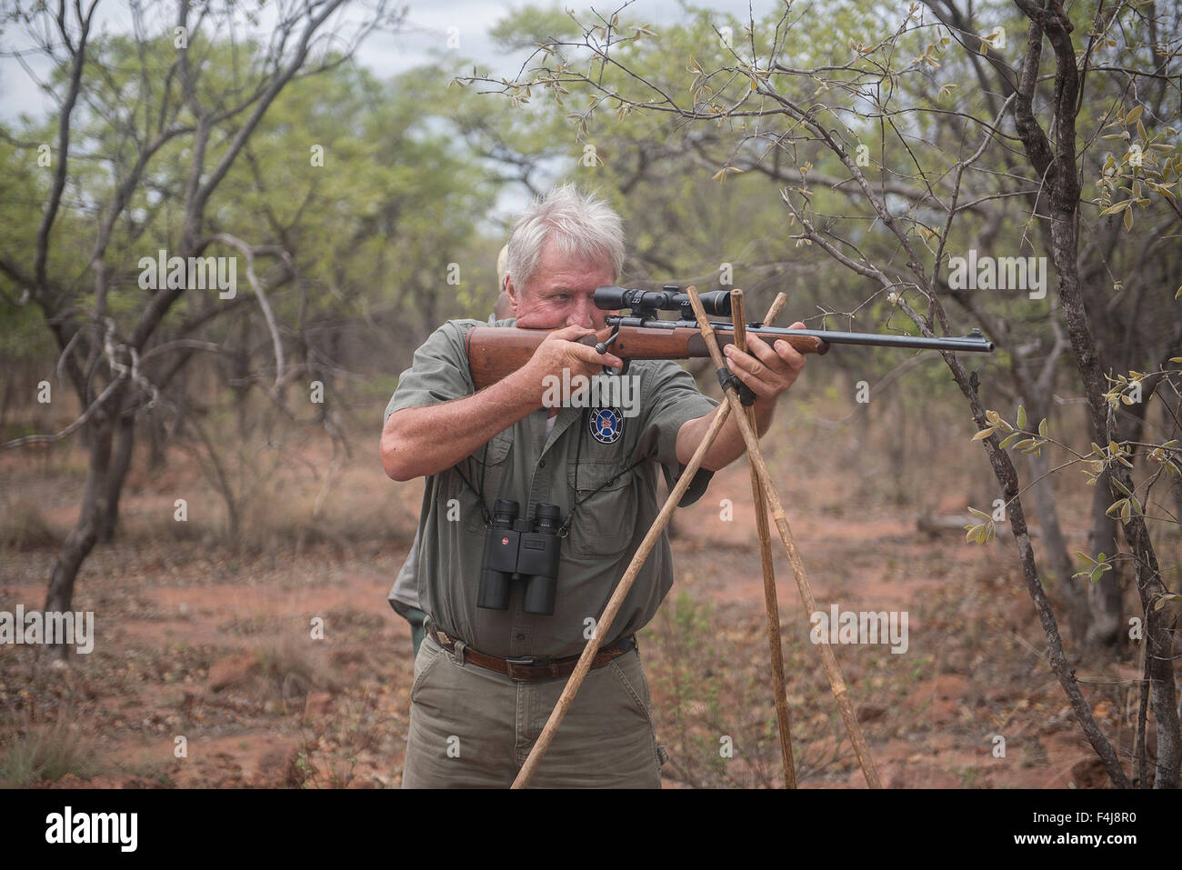 Professional Hunter, Stan Burger is seen holding his rifle taking aim ...