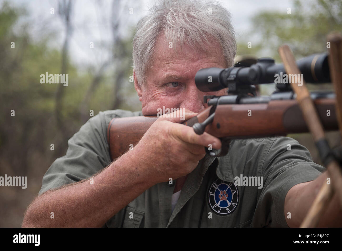 Professional Hunter, Stan Burger is seen holding his rifle taking aim ...