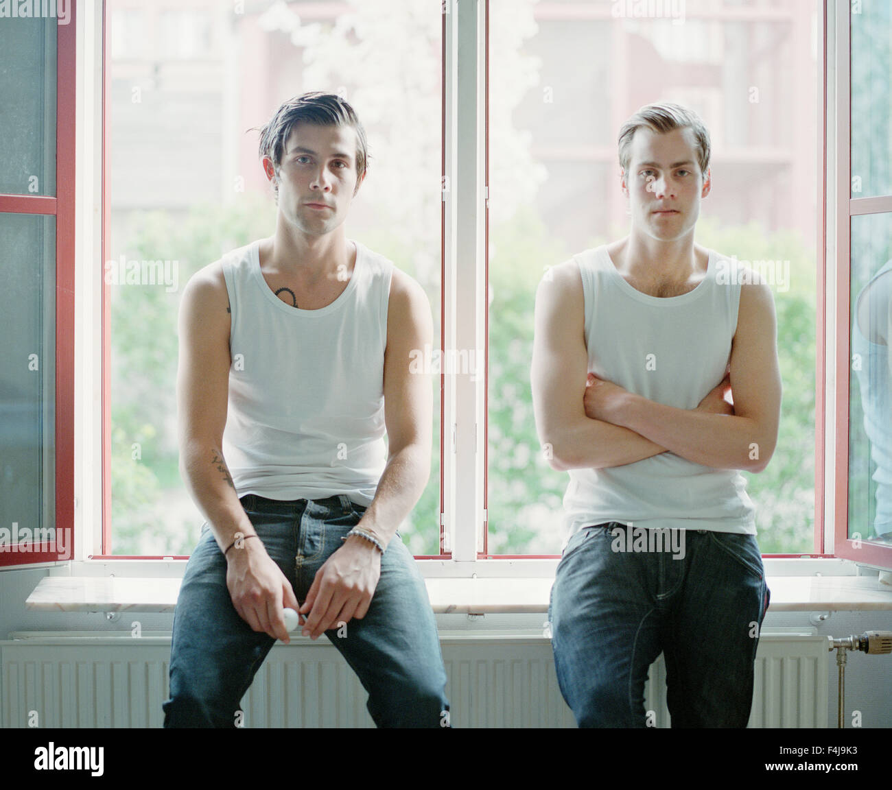 Two men sitting in a window Stock Photo - Alamy