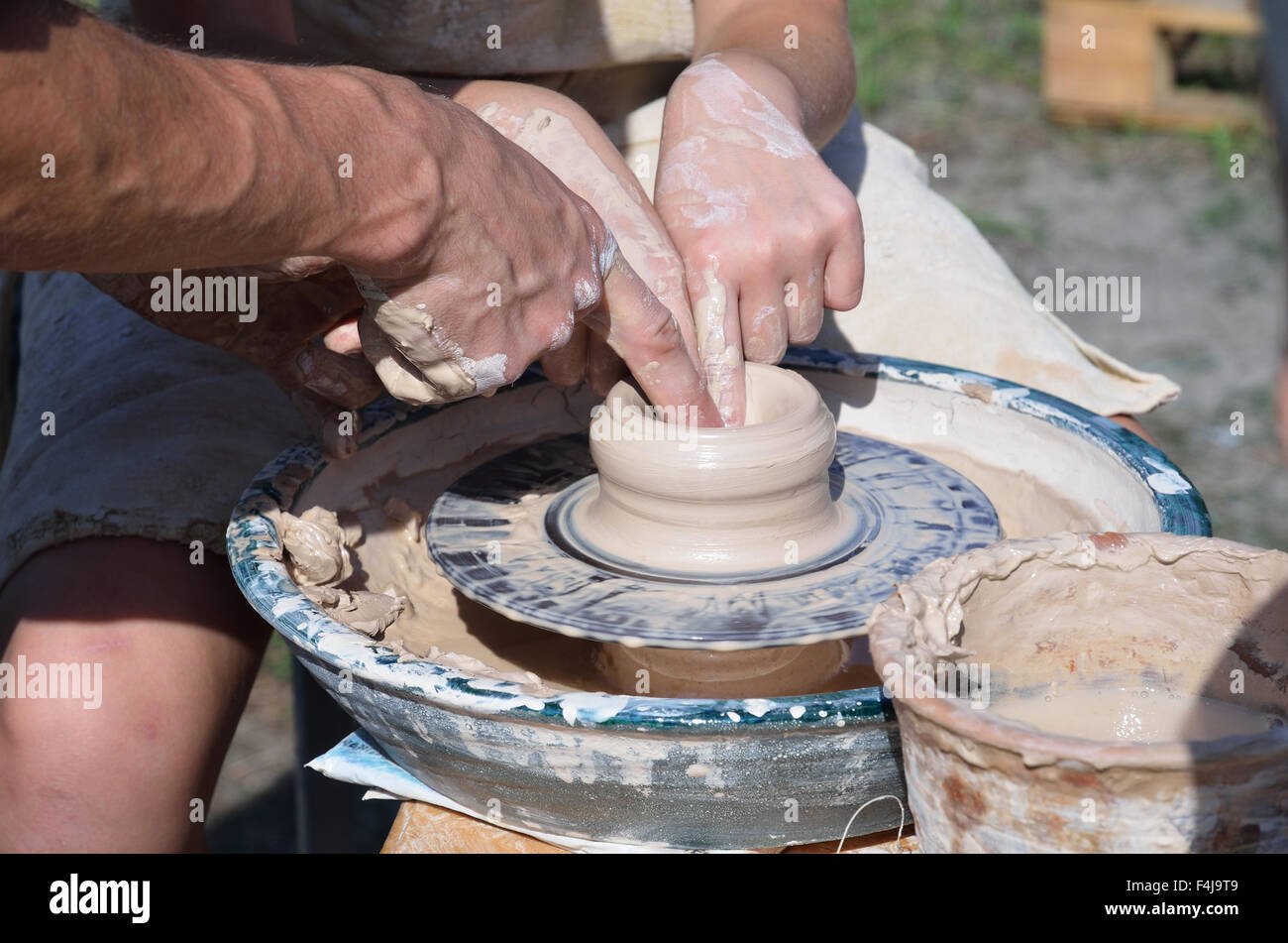 Potters working by the throwing wheel Stock Photo - Alamy