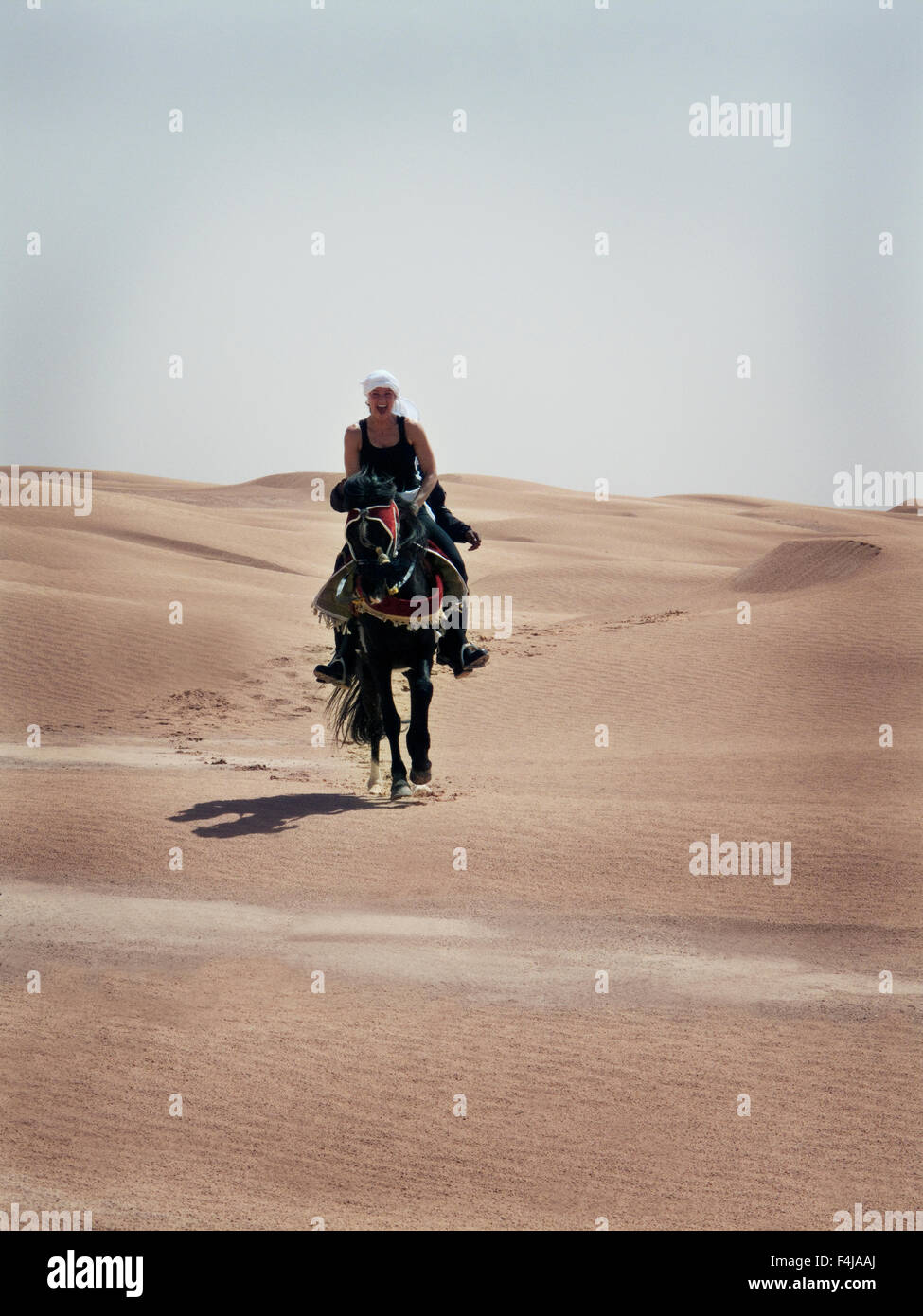 Woman riding a horse in the desert, Tunisia Stock Photo - Alamy