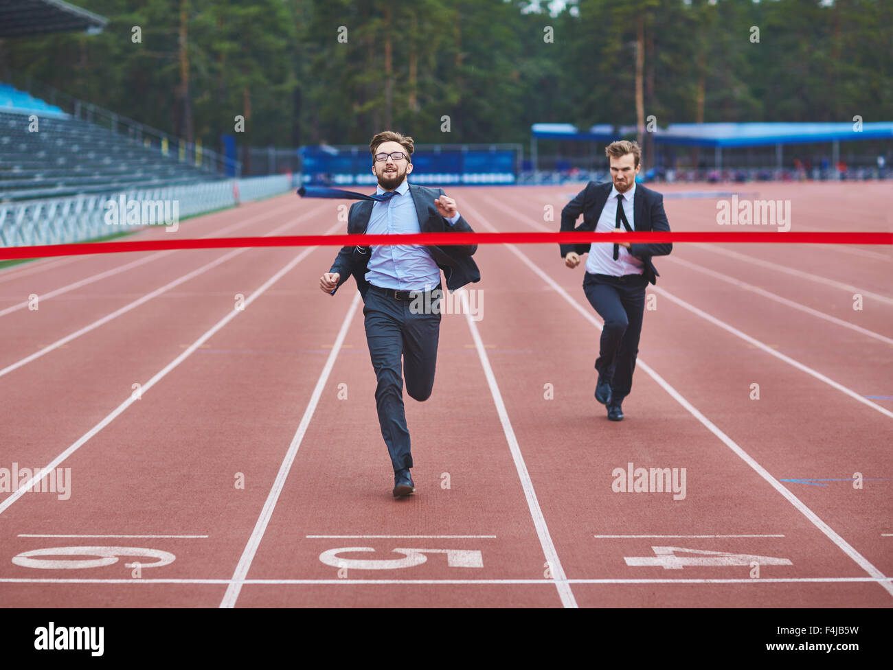 Successful businessman reaching finish and winning competition Stock ...