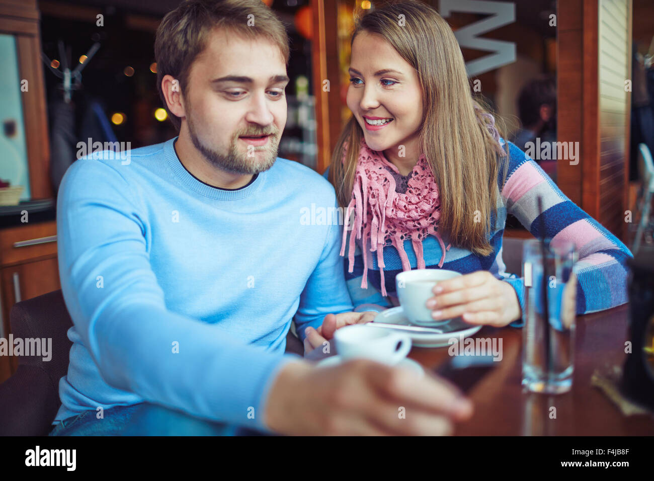 Romantic couple relaxing by cup of coffee Stock Photo - Alamy