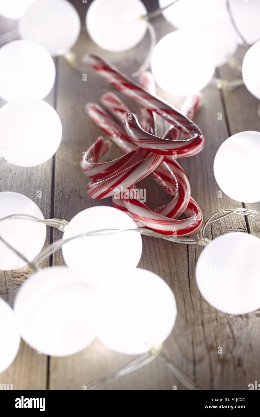 Candy canes on wooden table Stock Photo - Alamy