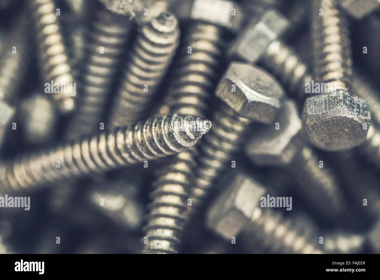 Pile of hex head metal screws for wood, industrial texture background ...