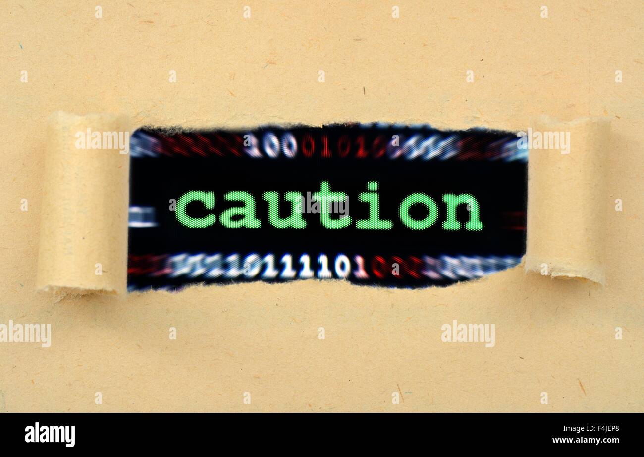 Caution text on ripped paper Stock Photo - Alamy