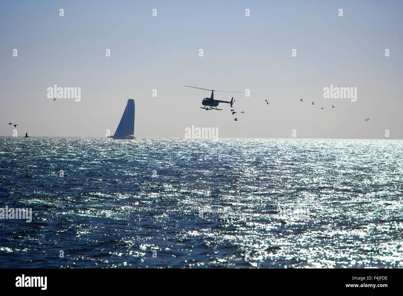 Ship sailing and helicopter flying over sea Stock Photo - Alamy