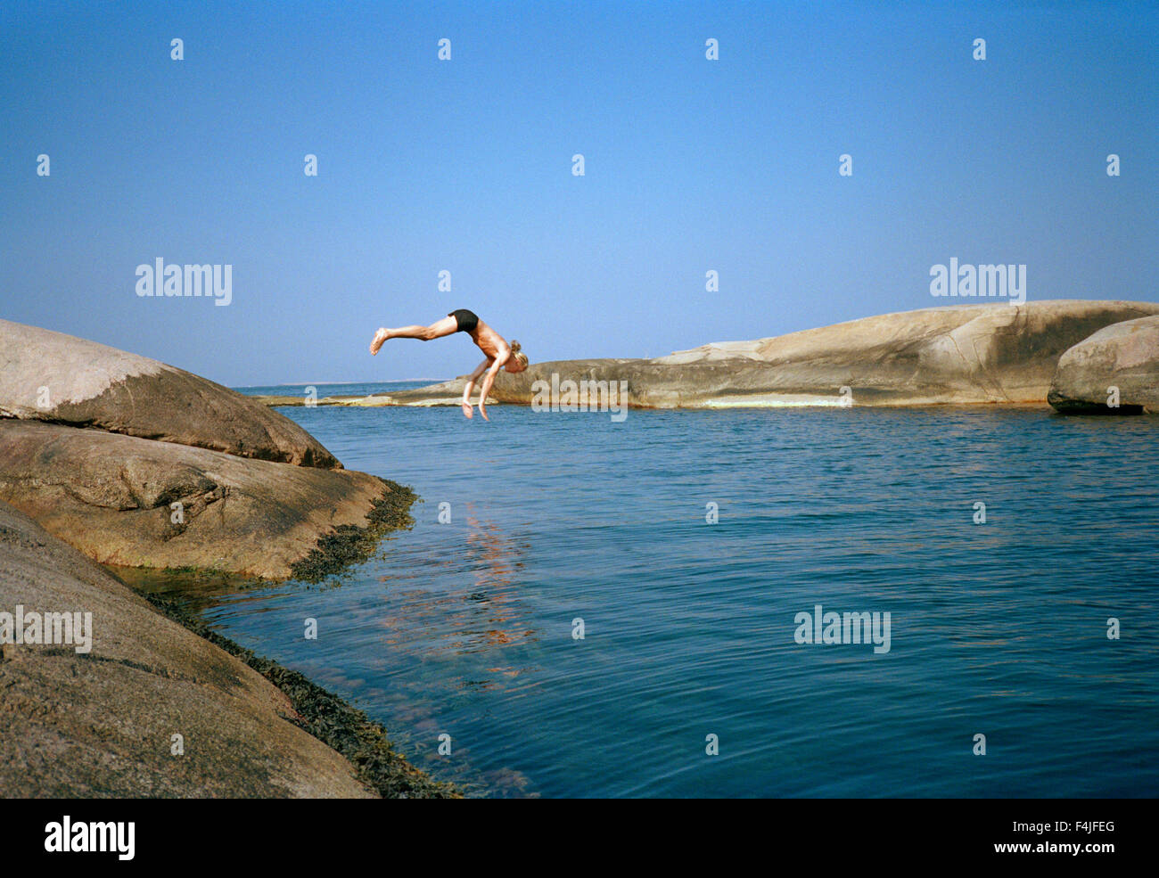 A man diving in to the ocean Stock Photo - Alamy