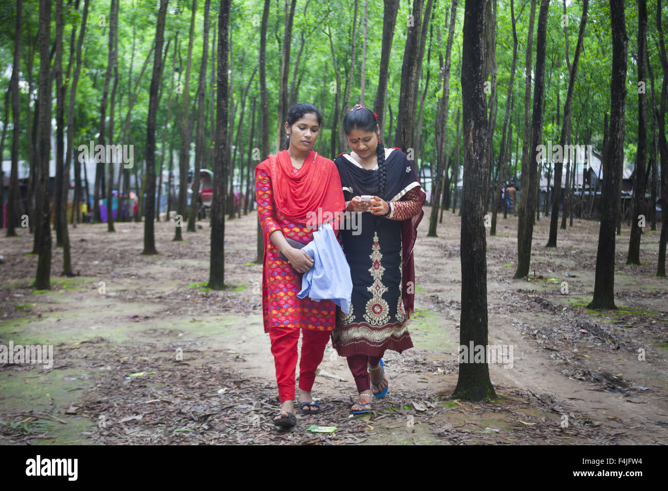 Dhaka, Bangladesh. 23rd Sep, 2015. Bangladeshi garments worker Shima Akhter, 18, cheats with her ...