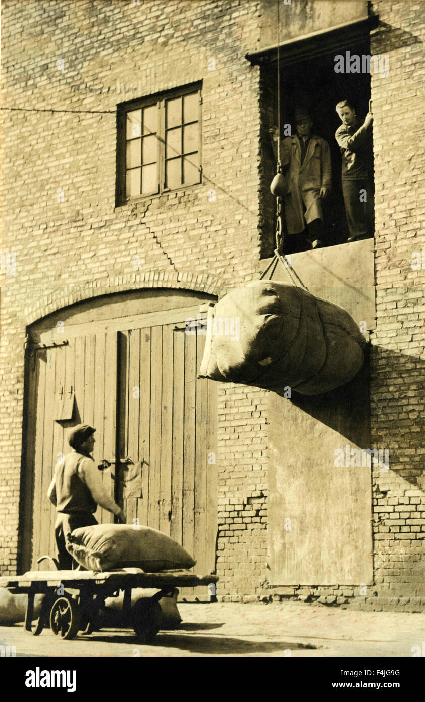 Two workers load of large parcels Stock Photo - Alamy