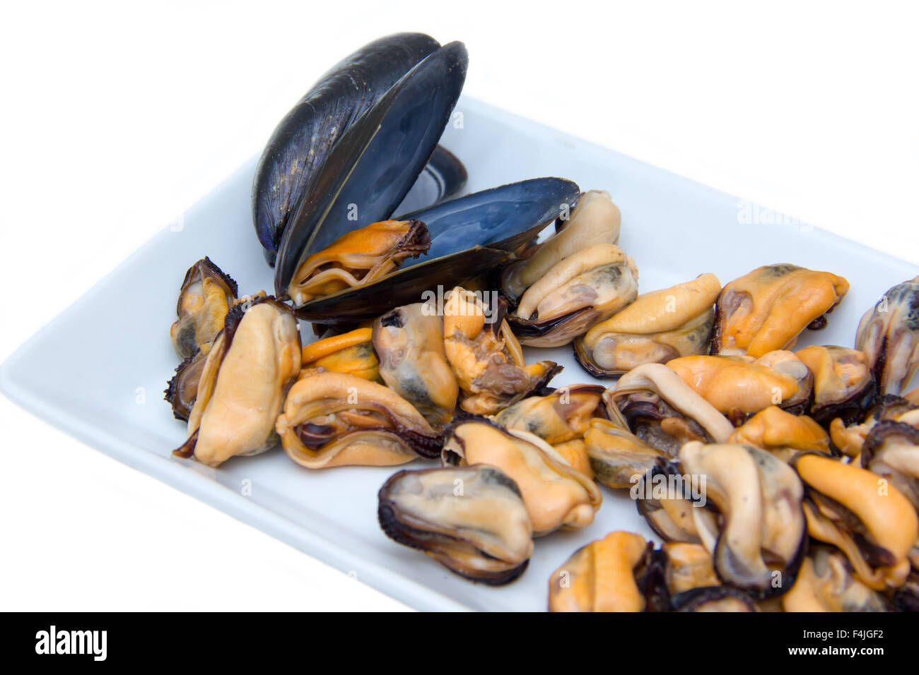 Mussels without shells on tray on white background close views Stock ...