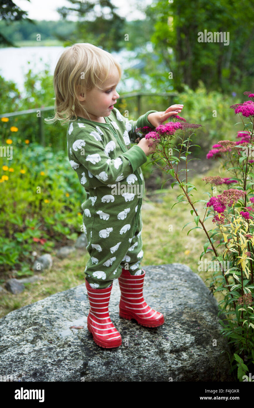 Girl touching flower Stock Photo - Alamy