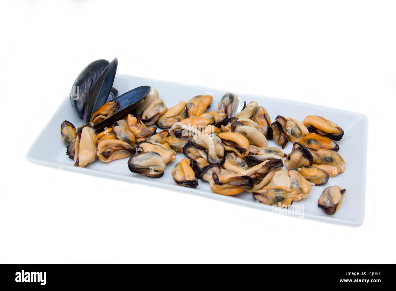 Mussels without shells on tray on white background Stock Photo - Alamy
