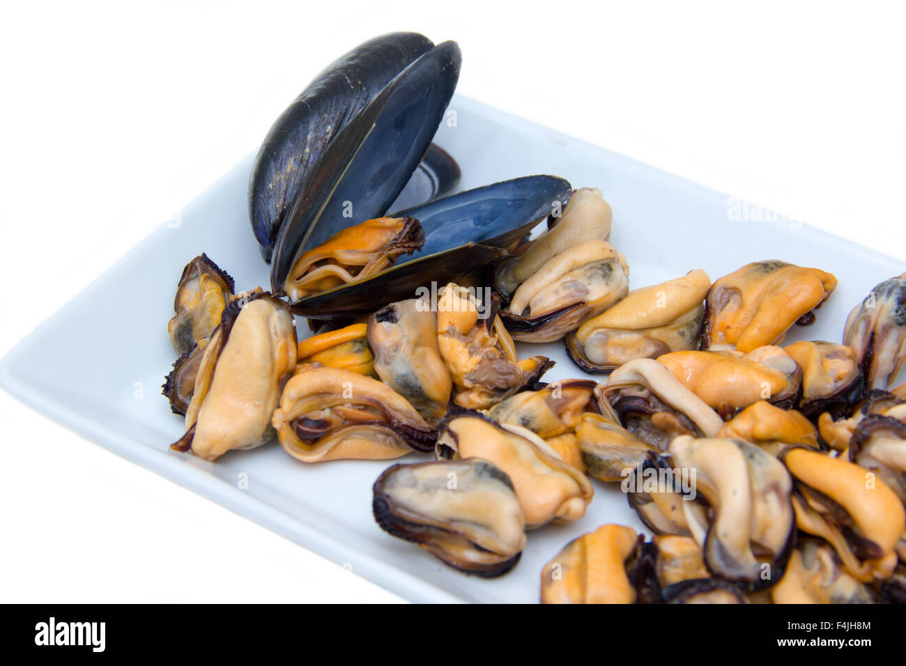 Mussels without shells on tray on white background close views Stock ...