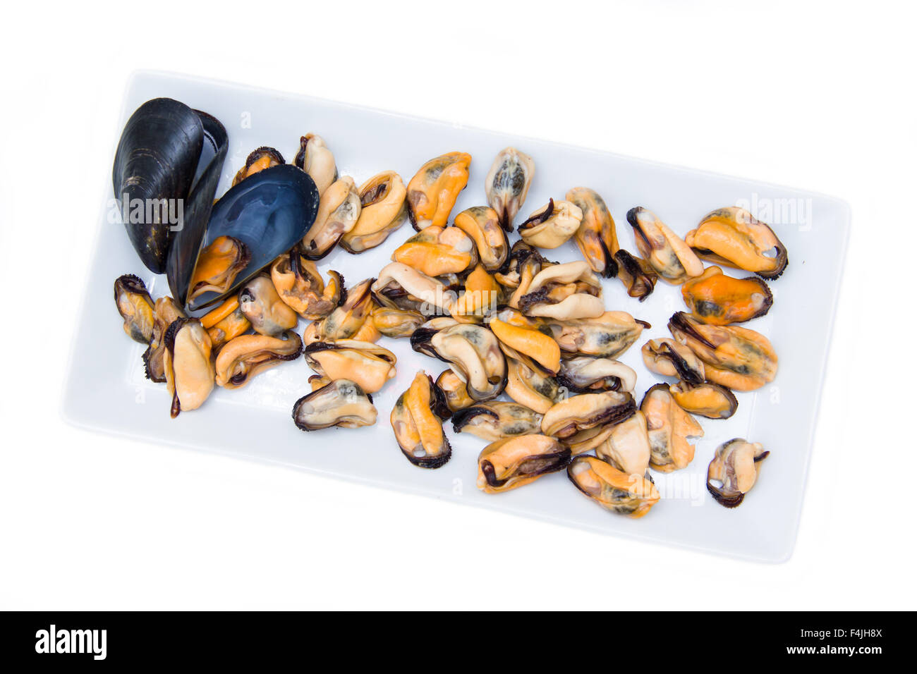 Mussels without shells on tray on white background seen from above ...