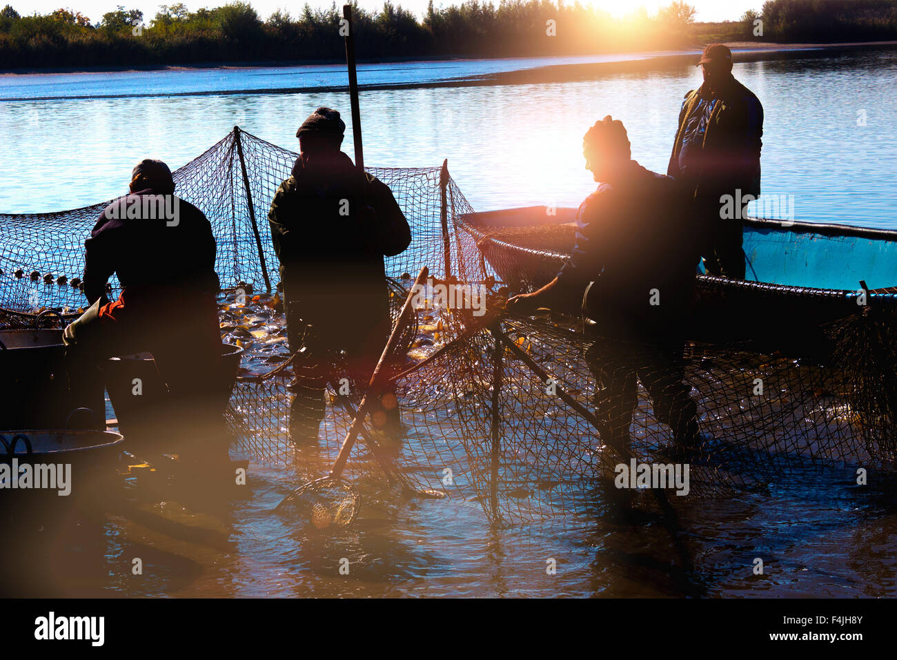 Fishing in the sunset Stock Photo - Alamy