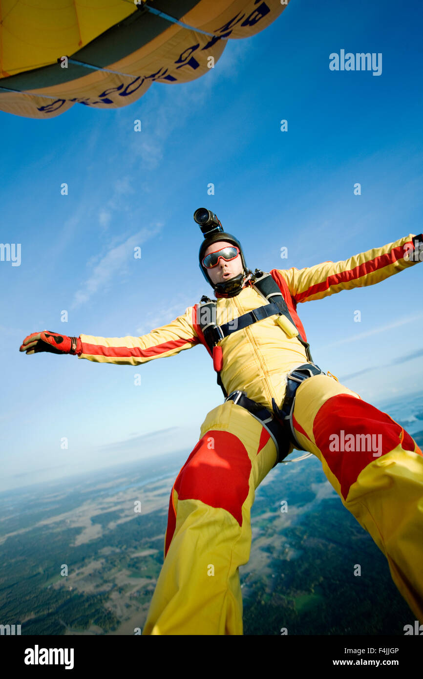 Portrait of man free falling from hot air balloon Stock Photo - Alamy