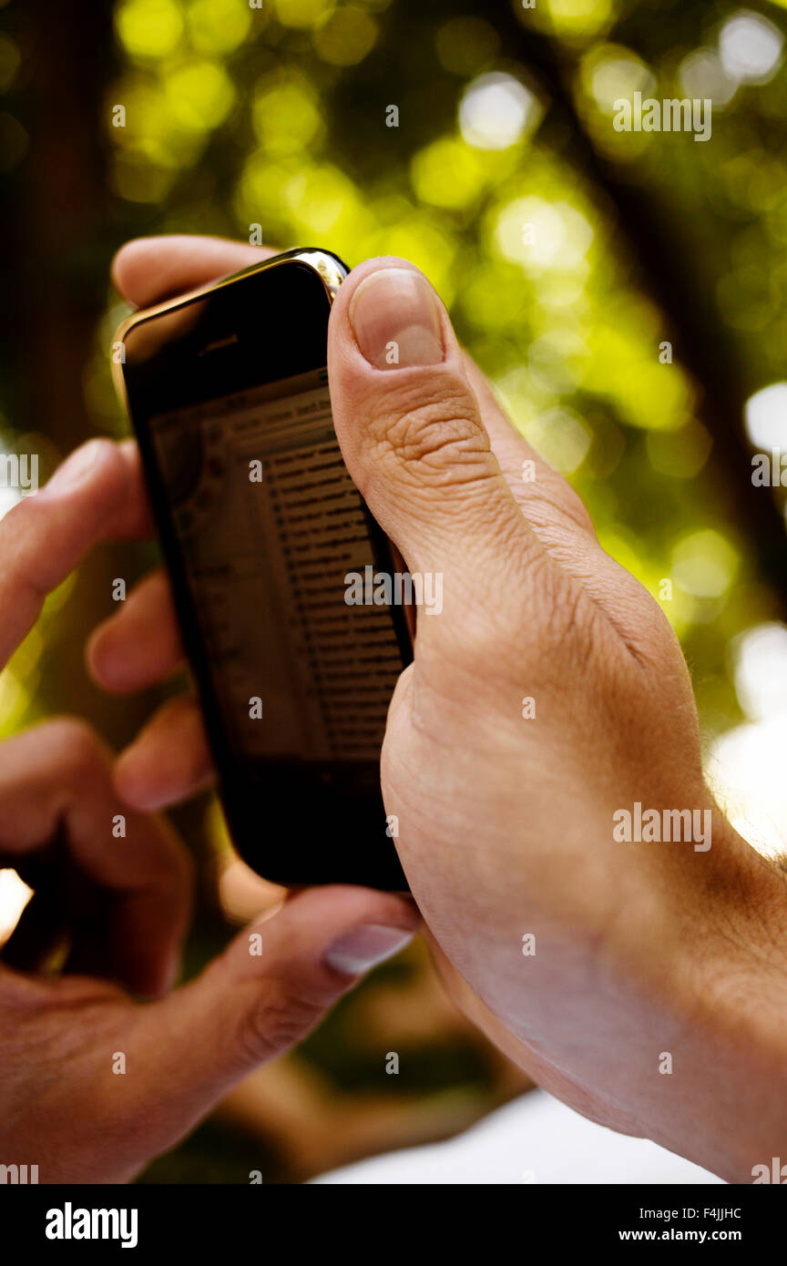 Mans hands holding mobile phone Stock Photo - Alamy