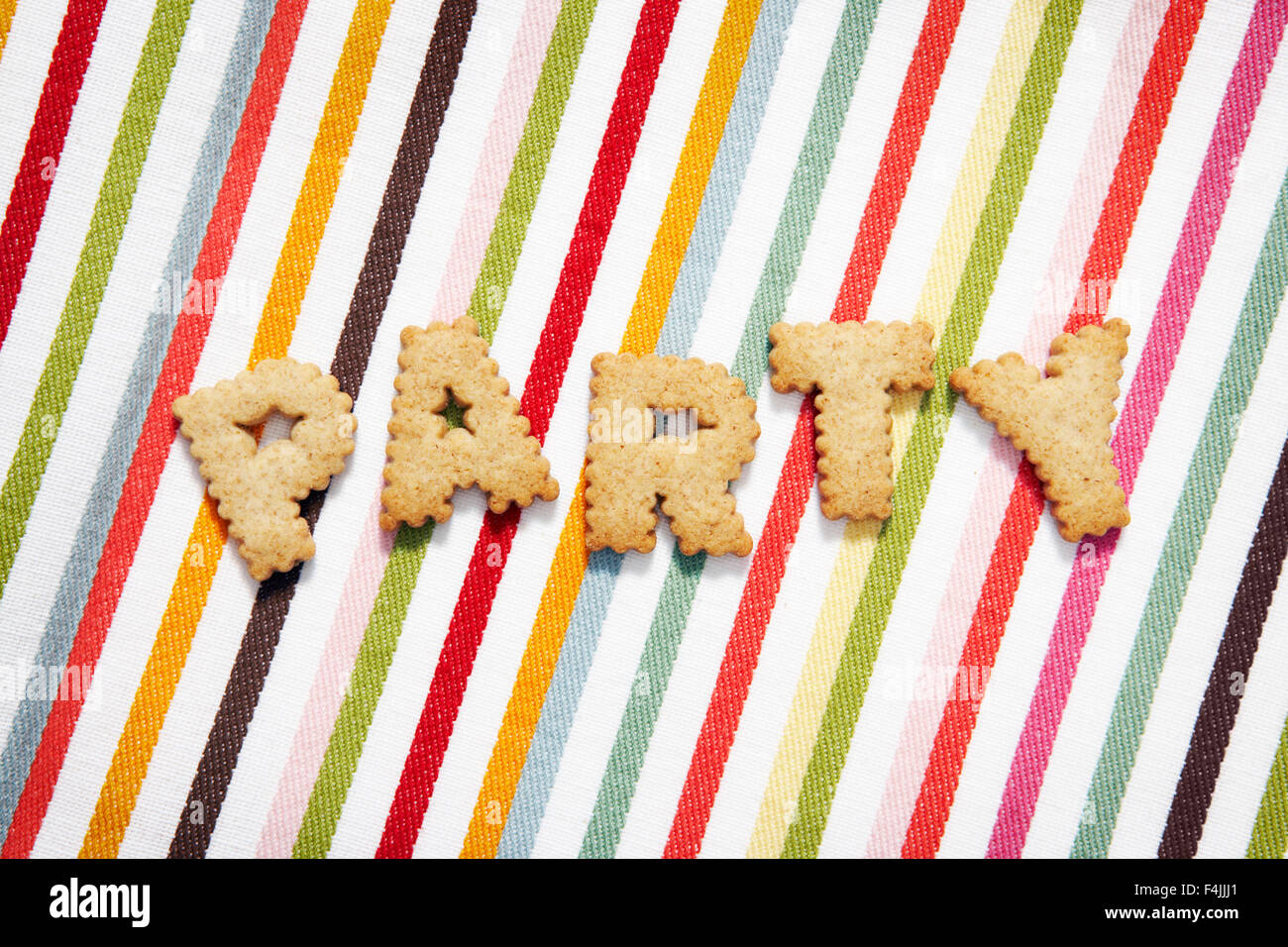 Party biscuits on striped background Stock Photo - Alamy