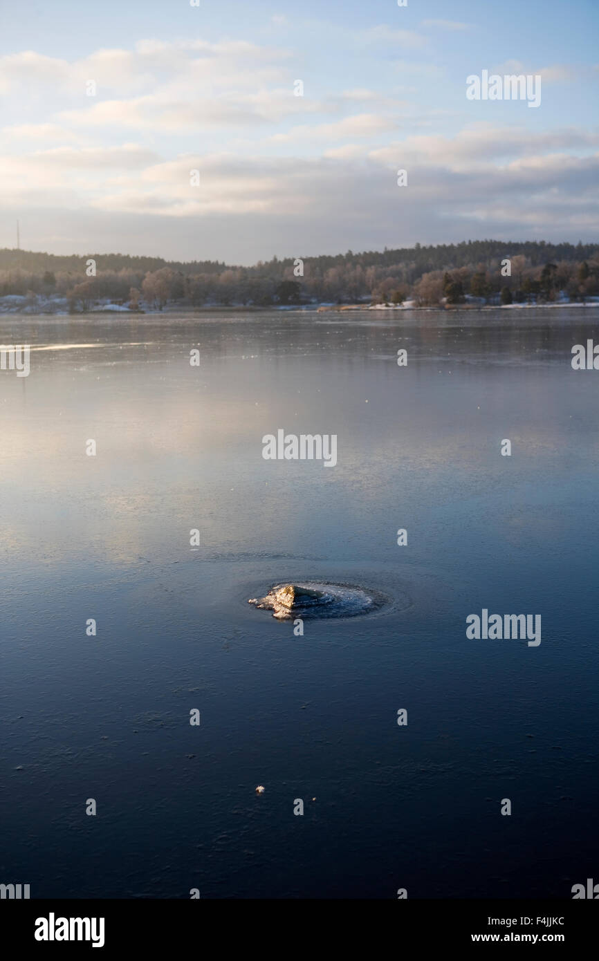 Frozen rock in bay Stock Photo - Alamy