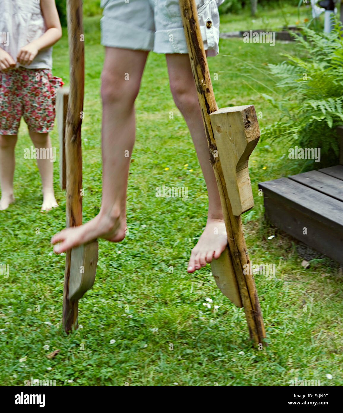 Sweden, girl (12-13) walking on stilts, low section Stock Photo - Alamy