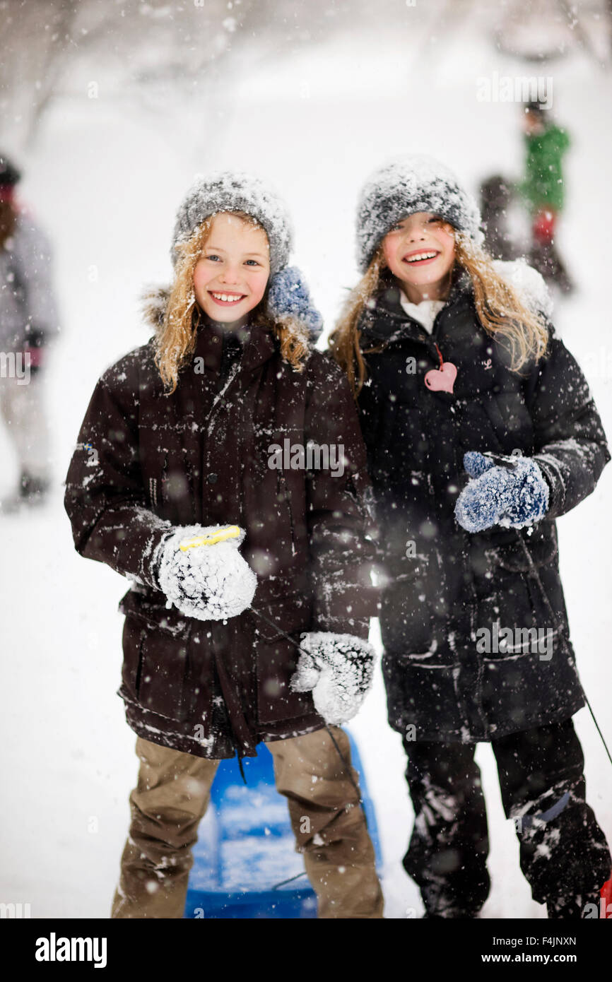 Sweden, Stockholm, portrait of identical tween girls (8-9) in snow ...