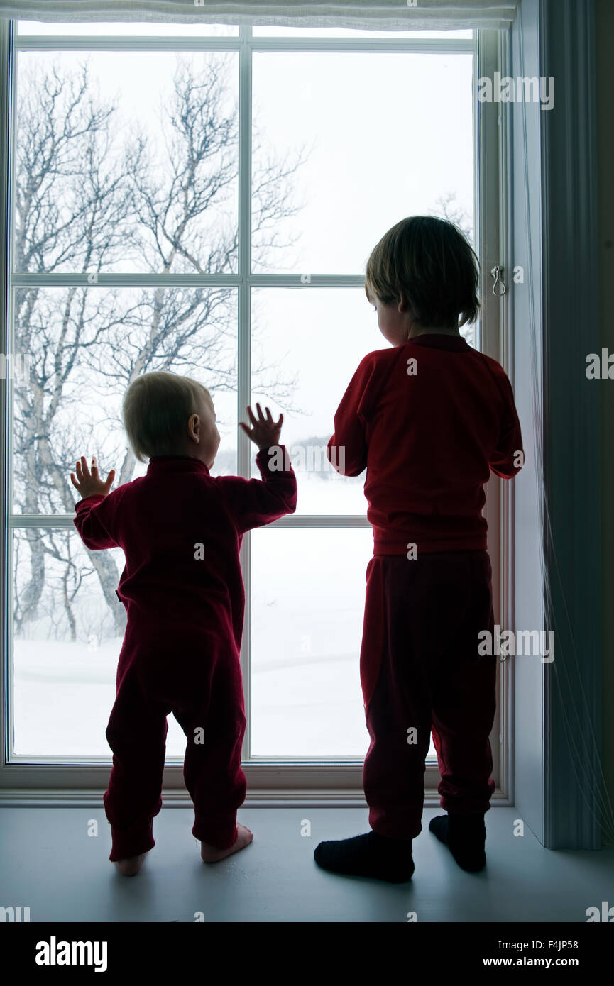 Silhouettes of children in window Stock Photo - Alamy