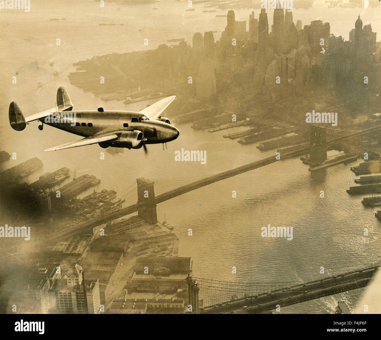 Plane flies over New York City, USA Stock Photo - Alamy