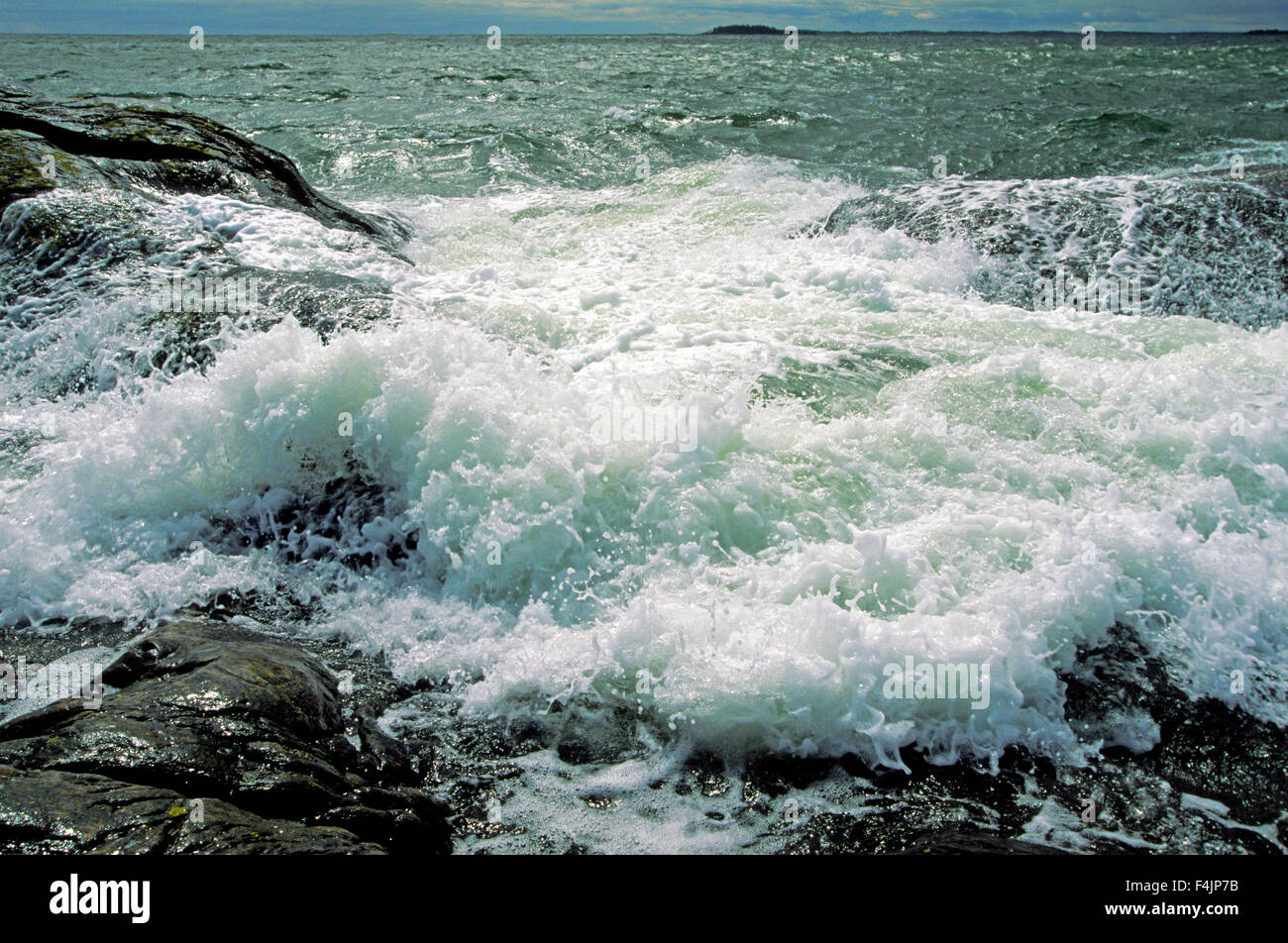 Surf on rocks at coast Stock Photo - Alamy