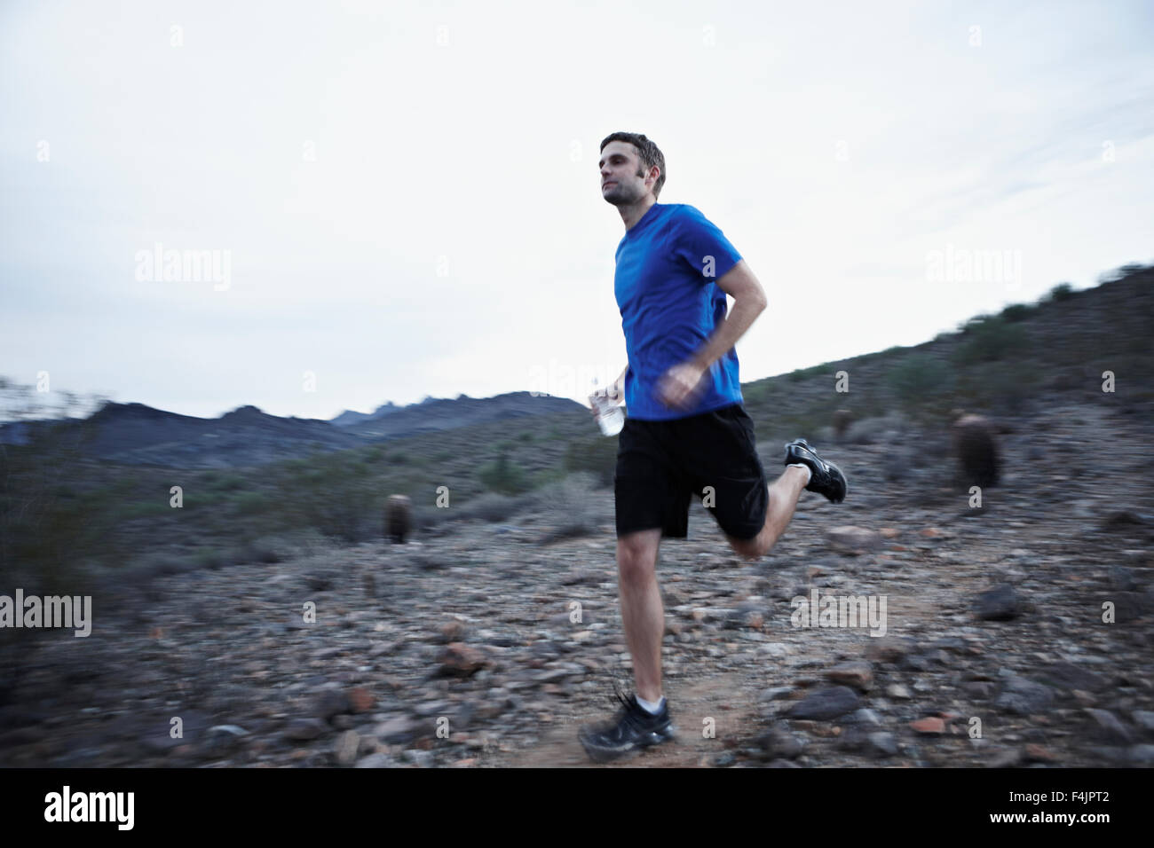 Man running on mountain trail Stock Photo - Alamy