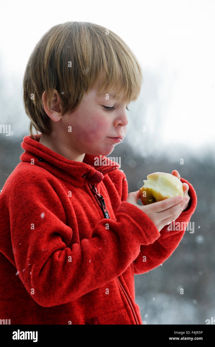 Boy eating apple Stock Photo - Alamy