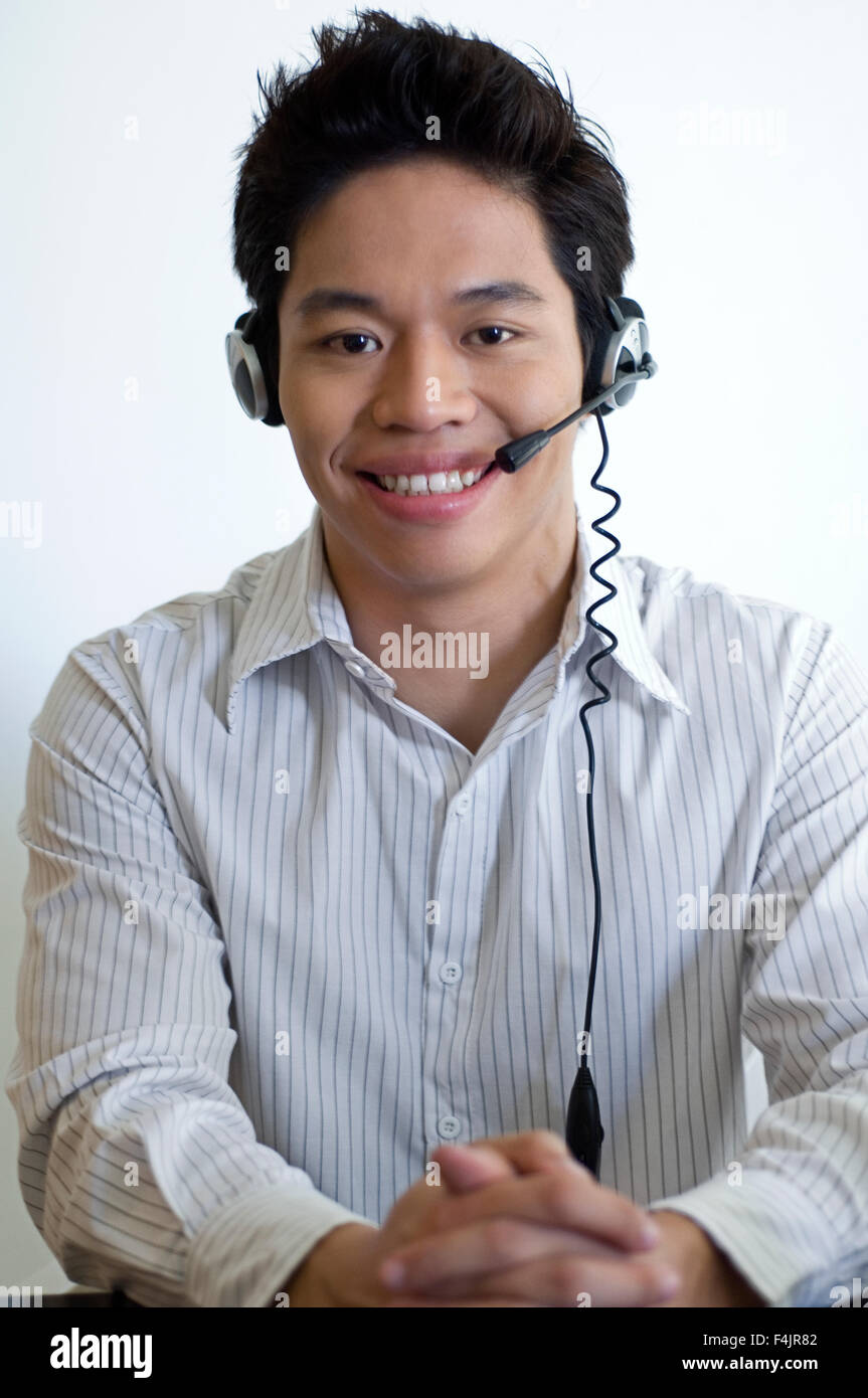Studio portrait of man using headset Stock Photo - Alamy