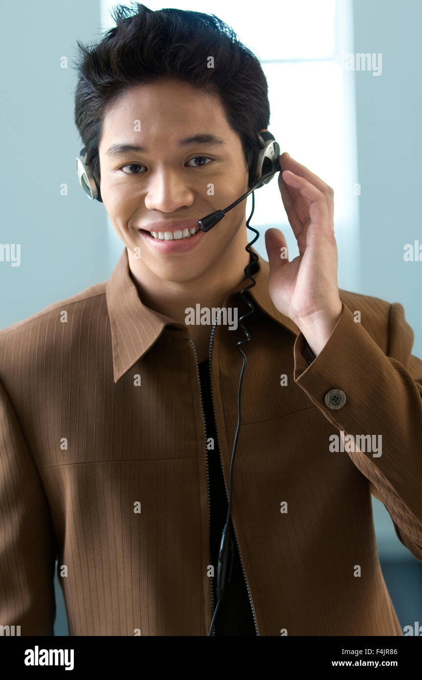 Portrait of man using headset Stock Photo - Alamy