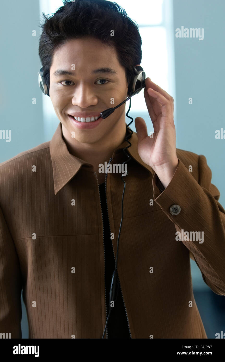 Portrait of man using headset Stock Photo - Alamy