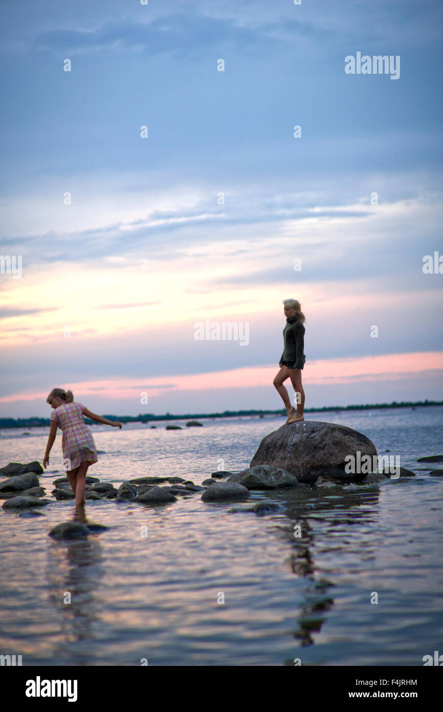Two children playing on rocks hi-res stock photography and images - Alamy