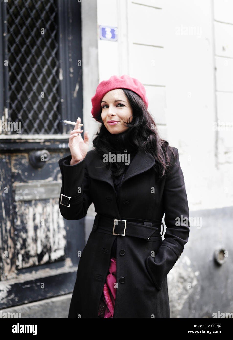 Portrait of woman smoking in street Stock Photo - Alamy