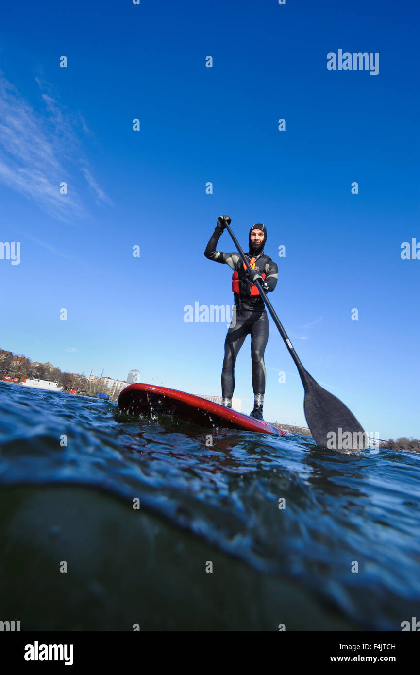 Man paddle boarding Stock Photo - Alamy