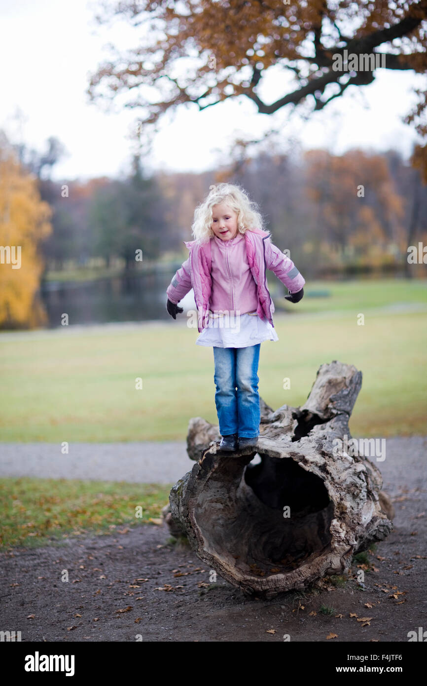Girl balancing on log Stock Photo - Alamy