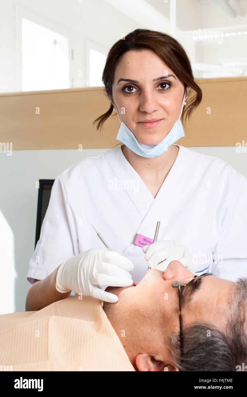 Dentist examining patient Stock Photo - Alamy