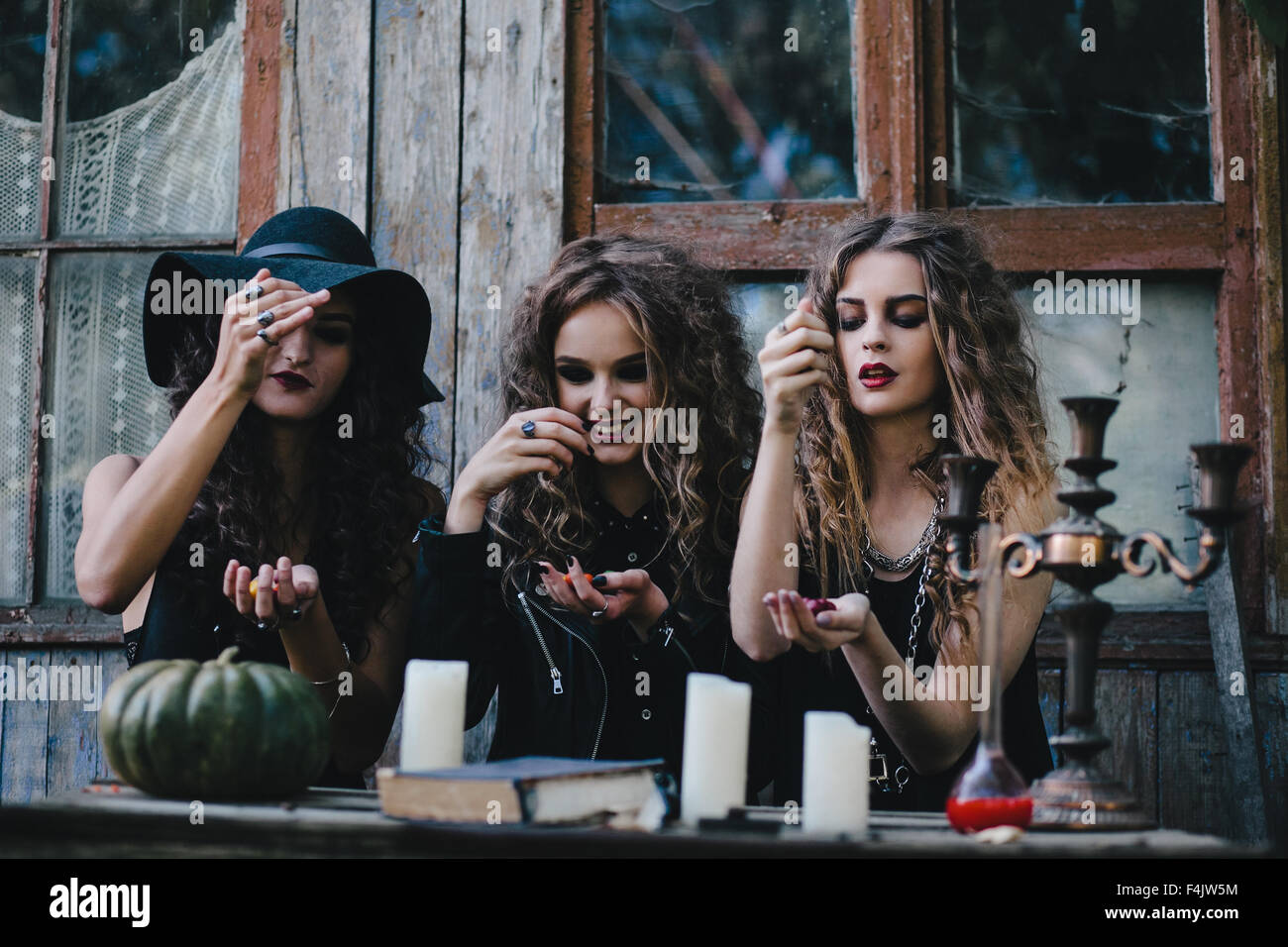 Three vintage witches perform magic ritual Stock Photo - Alamy