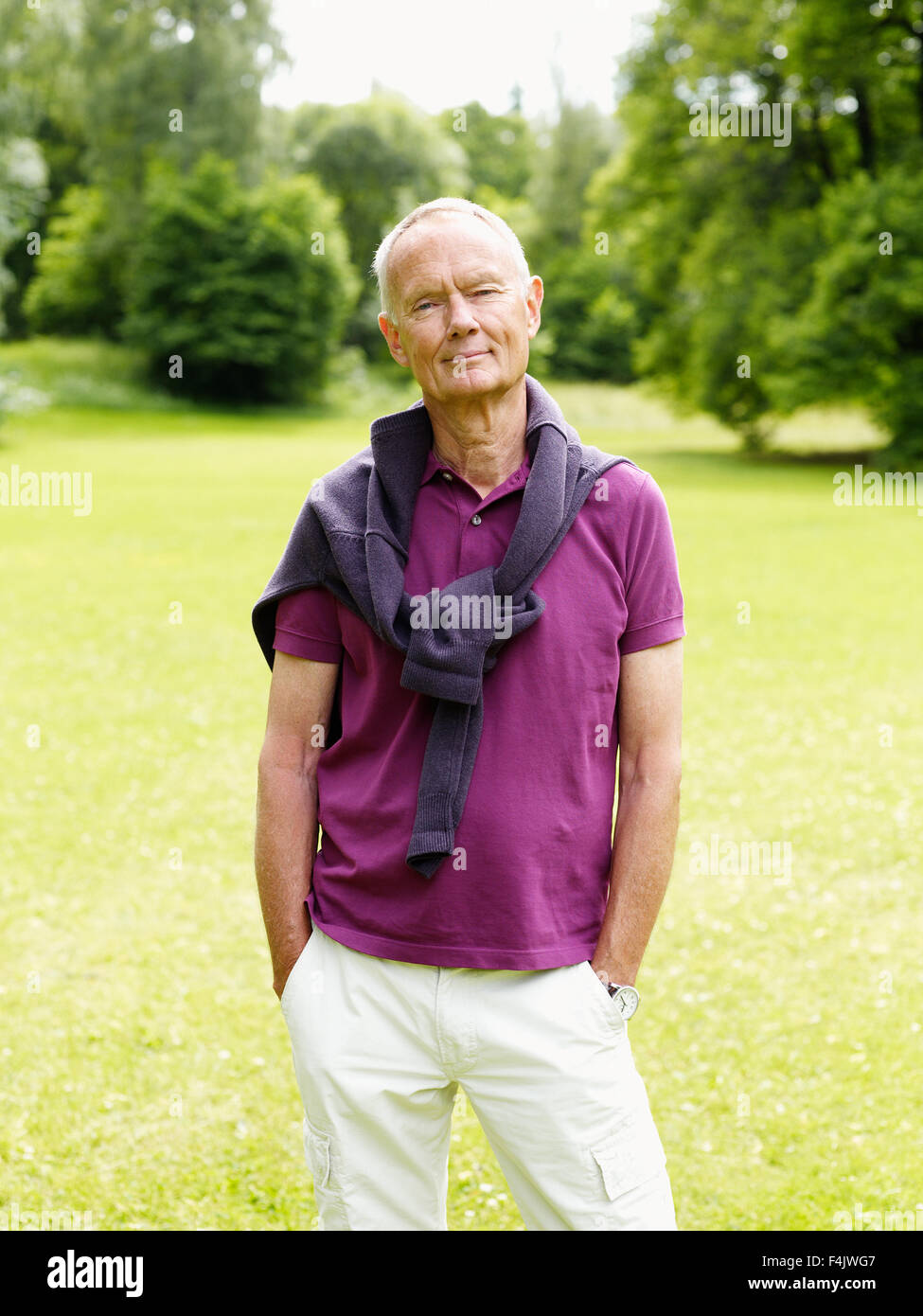 Senior man standing in park Stock Photo - Alamy