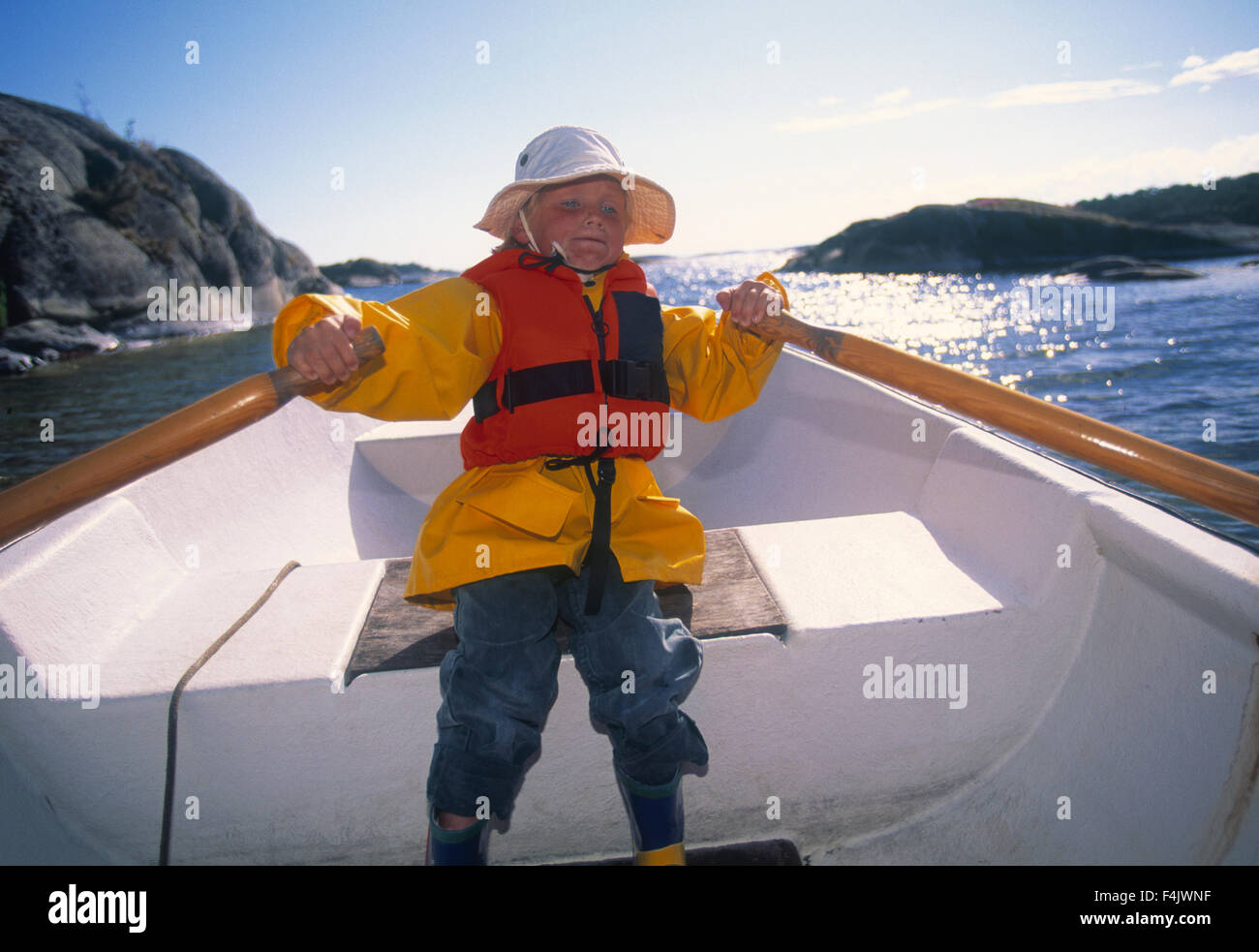 Boy rowing boat Stock Photo - Alamy