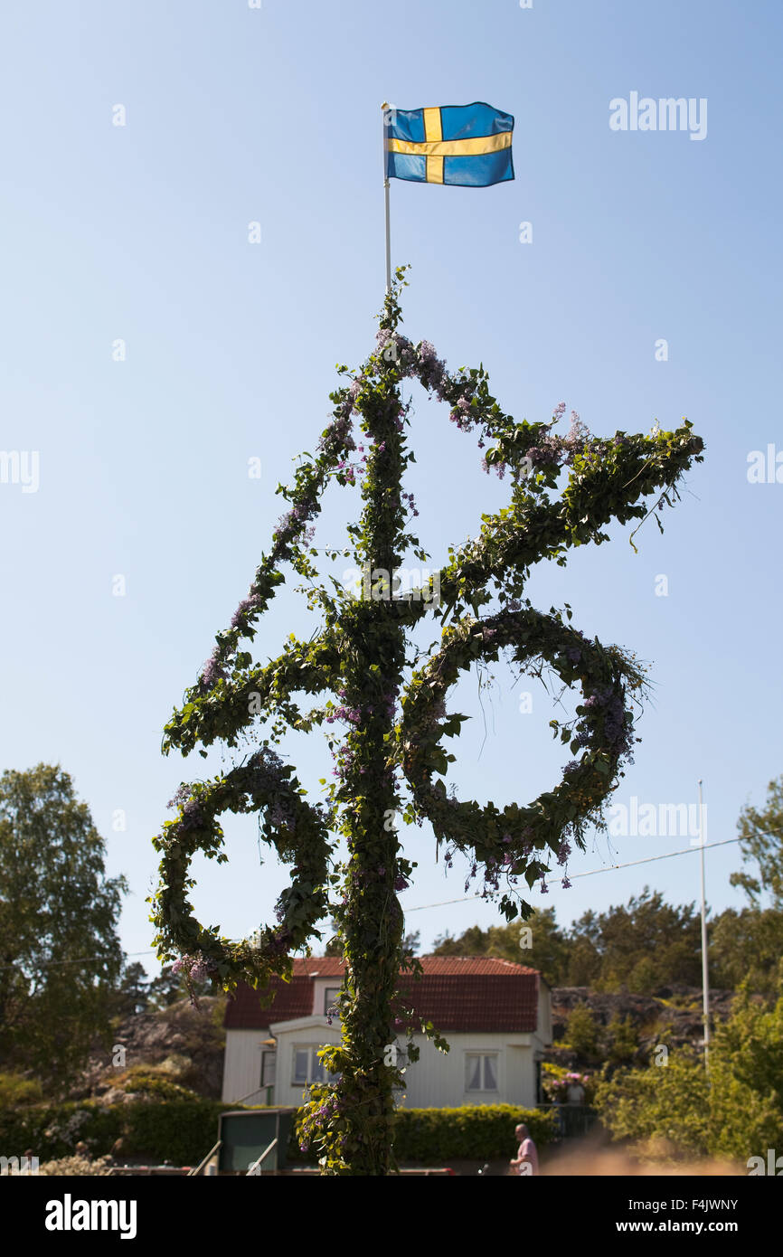 Maypole decorated with Swedish flag Stock Photo - Alamy