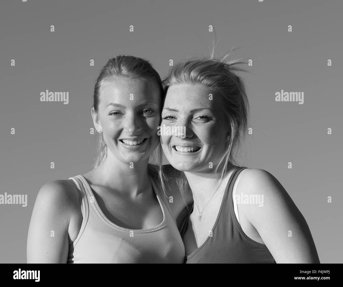 Two women standing with arm around, portrait Stock Photo - Alamy
