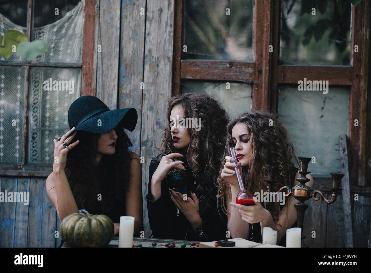 Three vintage witches perform magic ritual Stock Photo - Alamy