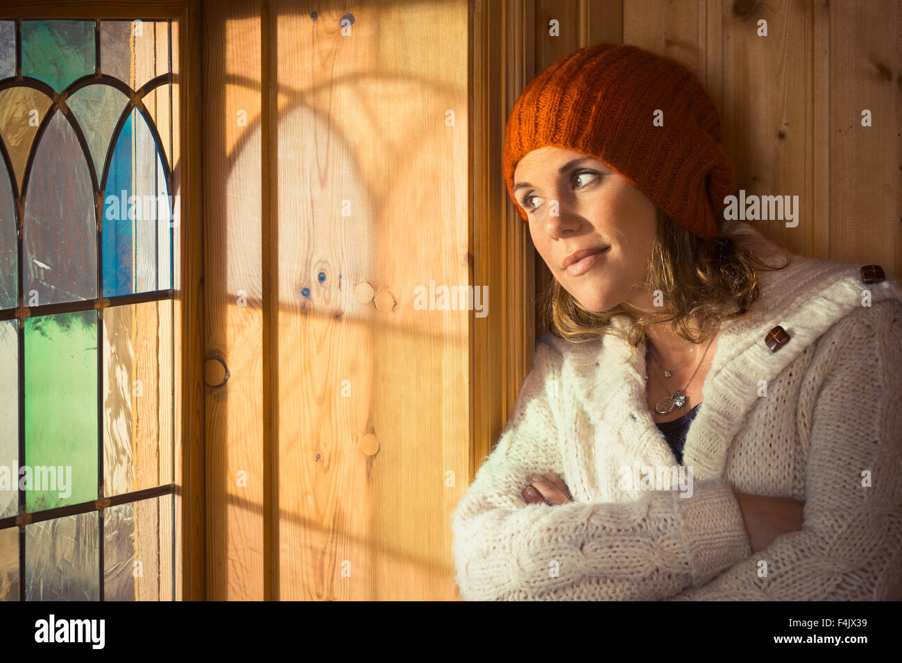 Woman looking through window, smiling Stock Photo - Alamy