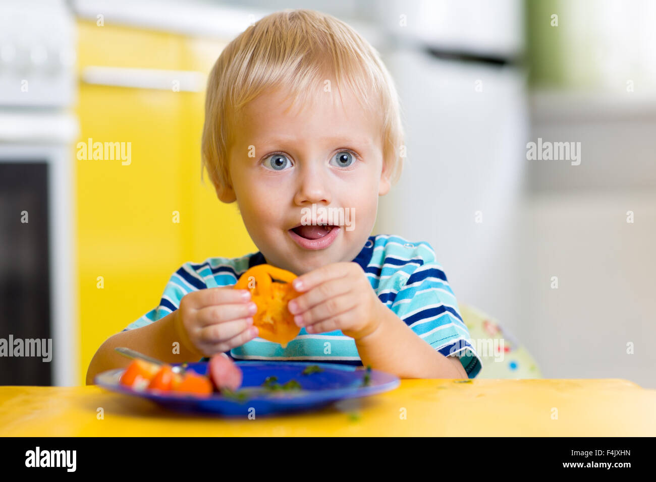 Cute child boy eats healthy food vegetables Stock Photo - Alamy